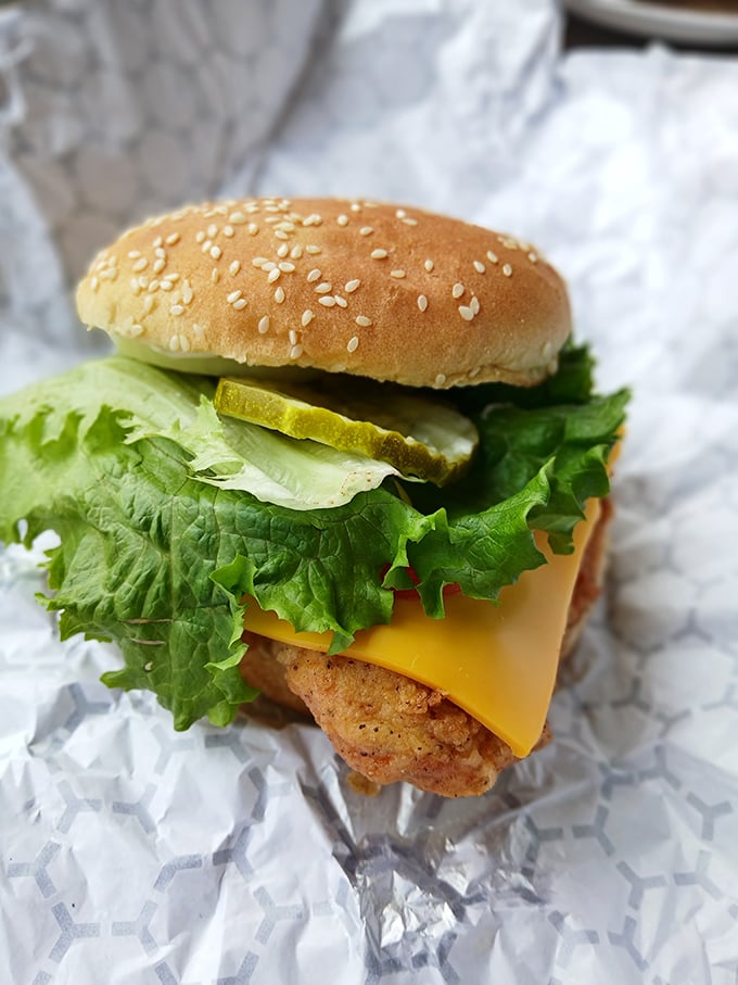 This isn't just a burger; it's architecture—layers of crispy, juicy, fresh, and melty coming together in handheld harmony.