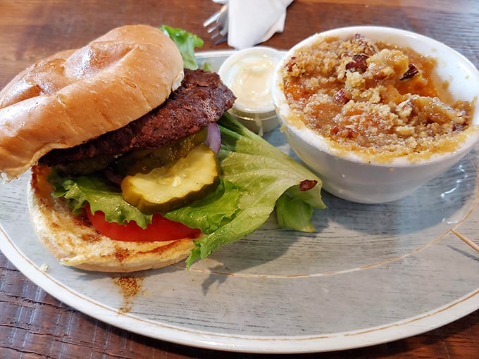 This isn't just a burger—it's architecture with attitude. That side dish appears to be apple crisp having an identity crisis as a savory option.