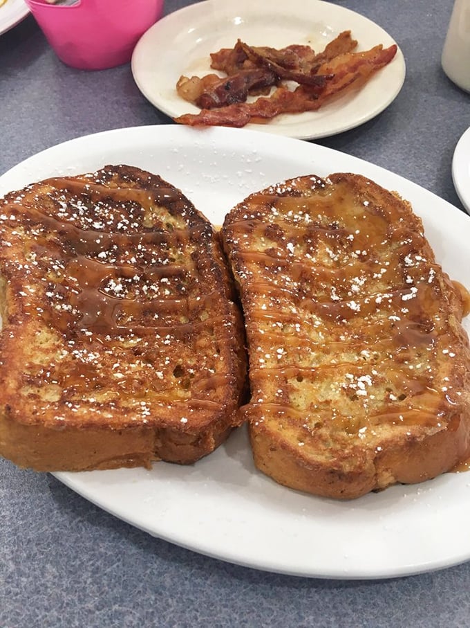 French toast that makes you question every other breakfast decision you've ever made. The powdered sugar isn't decoration—it's essential punctuation.