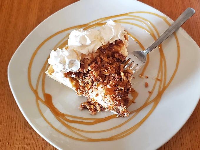 Caramel pecan pie with artistic sauce swirls – proof that dessert can be both a treat and a work of abstract expressionism.
