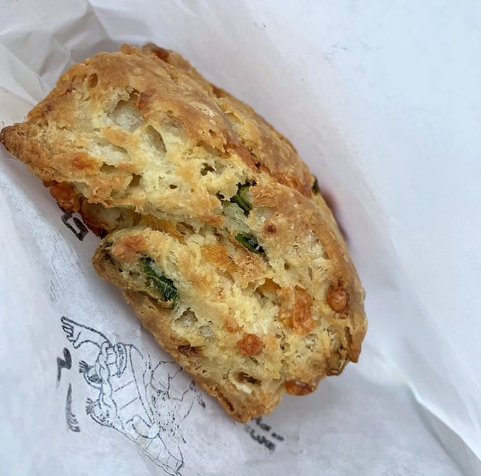 Behold the legendary scallion biscuit in its natural habitat – layers upon buttery layers with green flecks promising flavor that'll haunt your dreams for weeks.