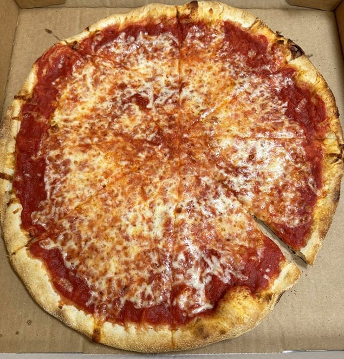 The classic cheese pizza—proof that perfection doesn't require complexity. That golden-brown crust edge deserves its own fan club.