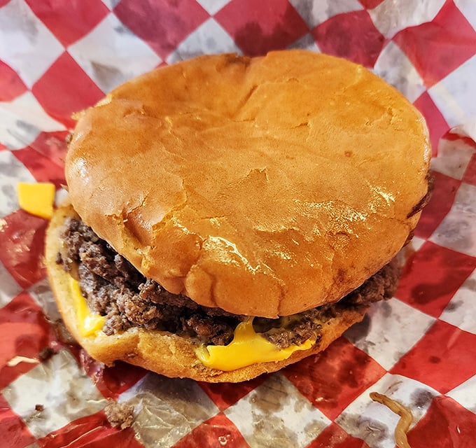 Behold the Hinkle cheeseburger in all its unpretentious glory—where American cheese melts into a thin, crispy-edged patty that puts gourmet versions to shame.