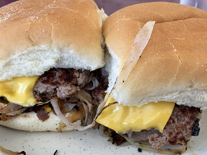 Behold the cross-section of burger perfection—where the melted American cheese meets caramelized onions and beef in a holy trinity of flavor.