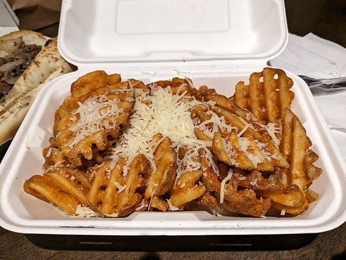 Waffle fries showered with cheese and seasoning – because sometimes your cheesesteak needs a supporting act that steals scenes.