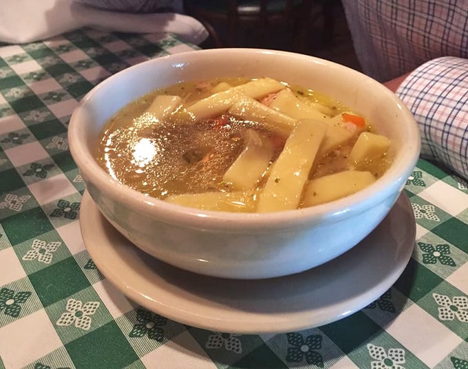 A bowl of chicken noodle soup that would make your grandmother nod in approval—thick, hearty noodles swimming in broth that's clearly not from a can.
