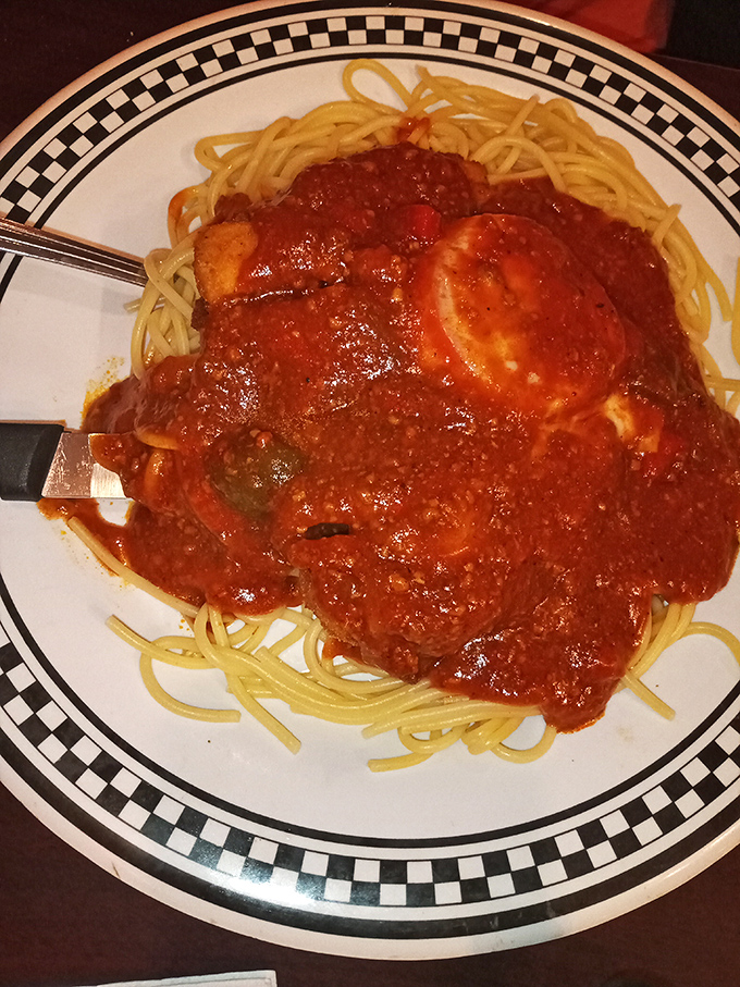 The star attraction! Chicken Parmesan sprawled across a bed of spaghetti like it owns the place—which it absolutely does. That sauce deserves a standing ovation.
