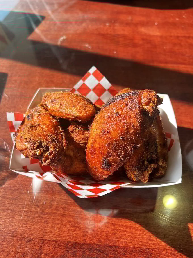 Dry-rubbed wings with a color that screams "I've been loved by smoke." These aren't afterthoughts—they're barbecue artistry in bite-sized form.