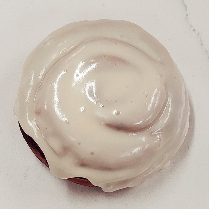 Behold the cinnamon roll in its natural habitat—swirled perfection topped with icing that melts just enough to make you forget all your troubles.