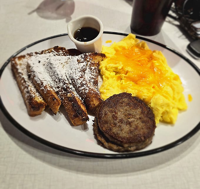 Breakfast that doesn't just start your day but celebrates it—French toast dusted with powdered sugar alongside eggs that practically glow.