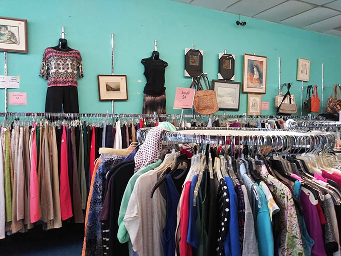 The clothing section's turquoise wall provides the perfect backdrop for fashion finds spanning decades – where vintage patterns meet contemporary classics.