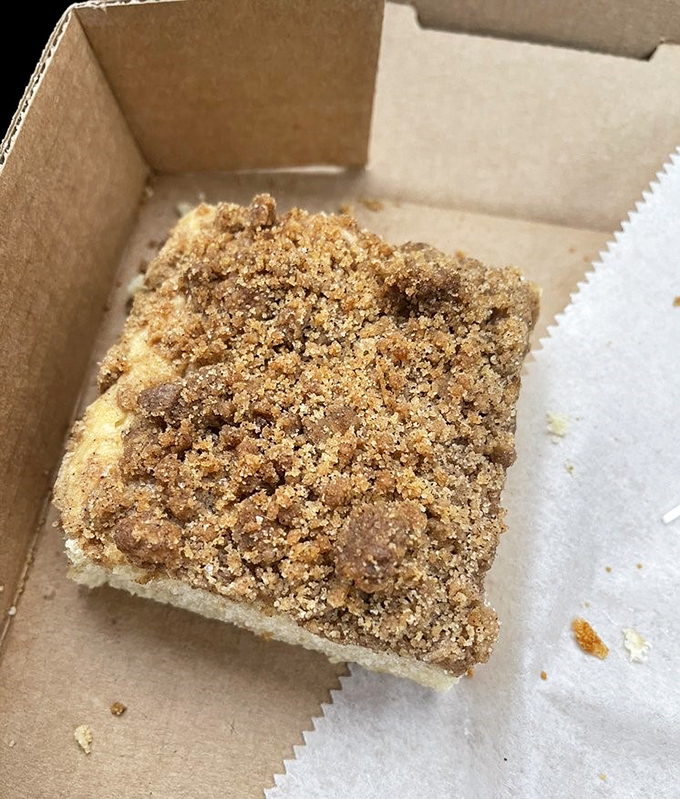 This cinnamon-topped coffee cake square proves Dottie's excellence extends beyond circular treats—corners have never been so worth cutting.