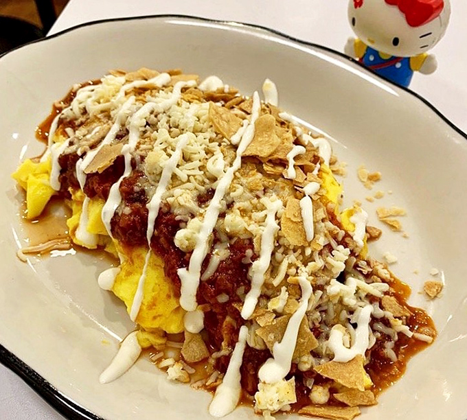 Breakfast reimagined—eggs meet chili, tortilla chips, and a drizzle of sauce in this morning masterpiece that makes alarm clocks worthwhile.
