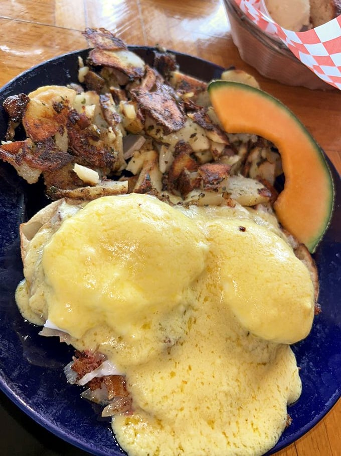The Benedict that launched a thousand road trips: poached eggs nestled on hash, draped in Hollandaise, with perfectly crispy potatoes standing guard.