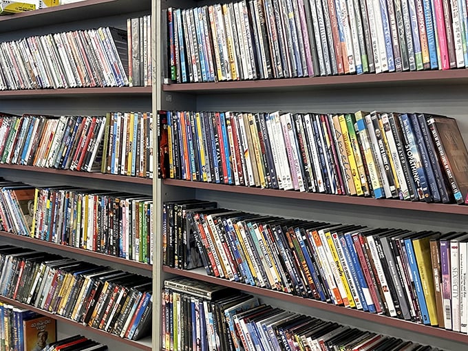 The DVD wall – a physical Netflix from another era where browsing meant actually touching the cases and reading the backs.