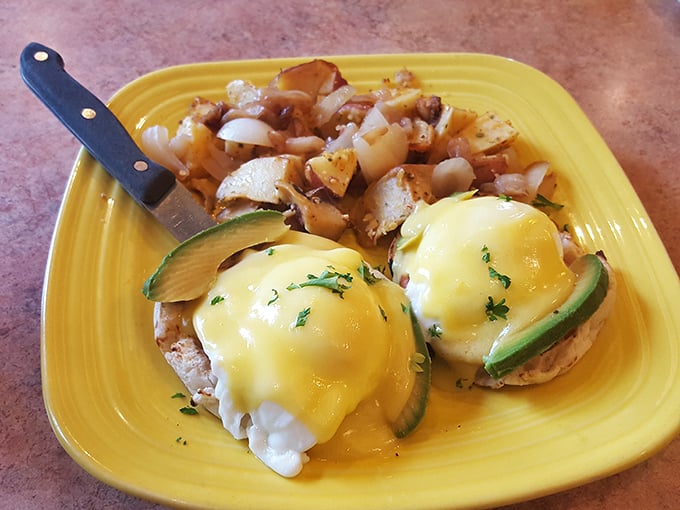 Eggs Benedict with a twist—cucumber adds freshness to this breakfast classic. The bright yellow plate is practically radiating happiness, much like your taste buds will be.