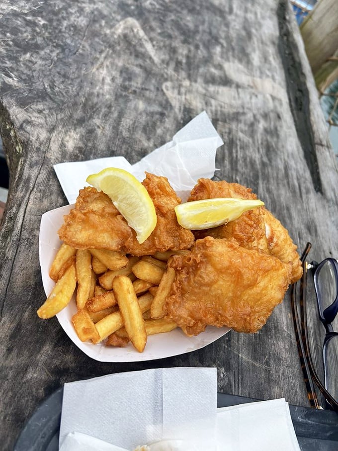 The platonic ideal of fish and chips—crispy exterior giving way to flaky perfection, with lemon wedges standing by for their supporting role.