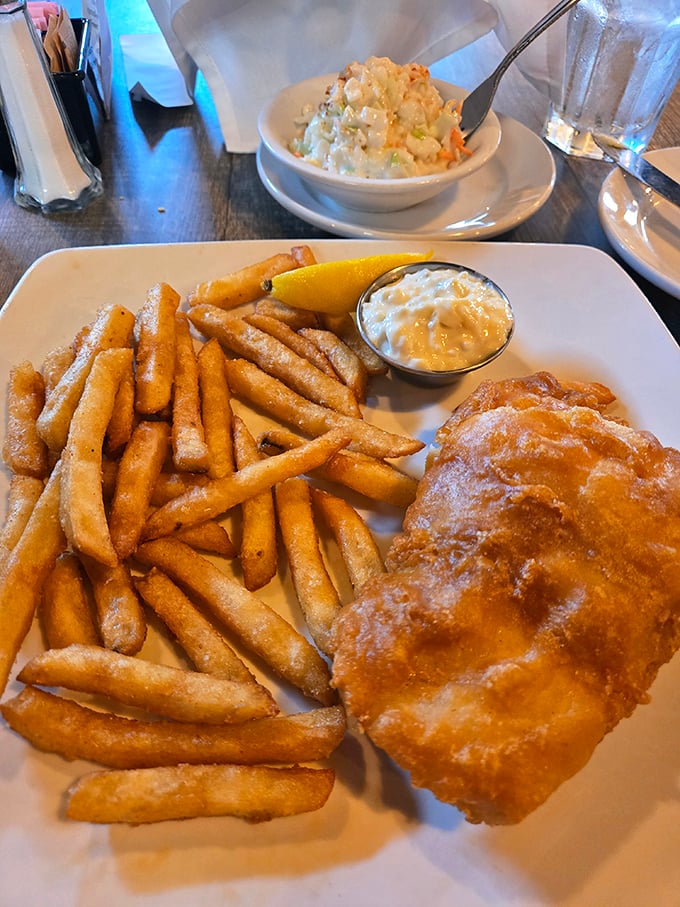 Fish and chips with a side of coleslaw – comfort food that crosses international waters. That golden batter is what dreams and cheat days are made of.