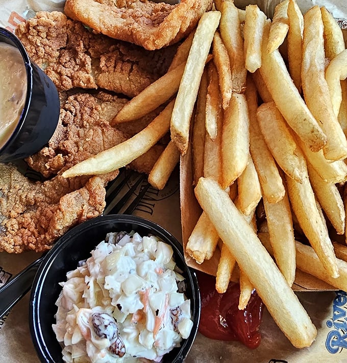 Golden fries, crispy fish, and homemade coleslaw—the holy trinity of beach comfort food that tastes like vacation on a plate.