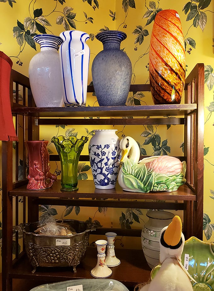 A rainbow of vintage vases stands at attention against cheerful yellow wallpaper – each one ready to showcase your farmers' market blooms.