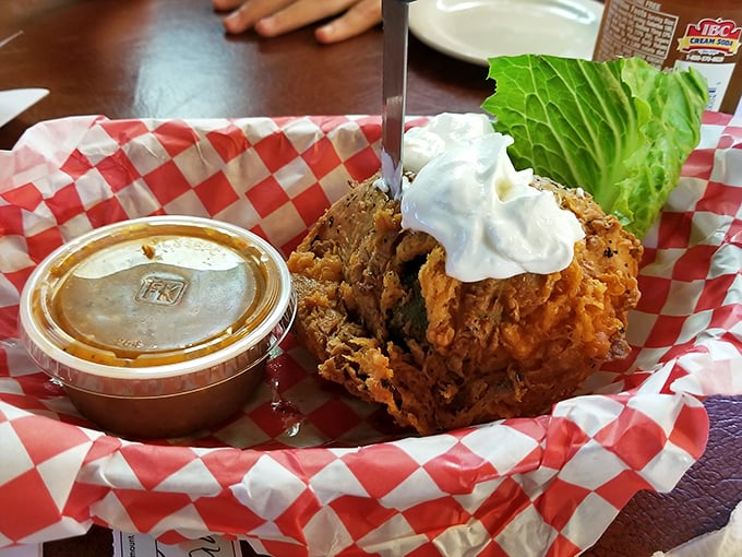 The fried avocado arrives like a crispy golden orb of Tex-Mex ingenuity. Whoever first decided to batter and fry an avocado deserves a Nobel Prize. 
