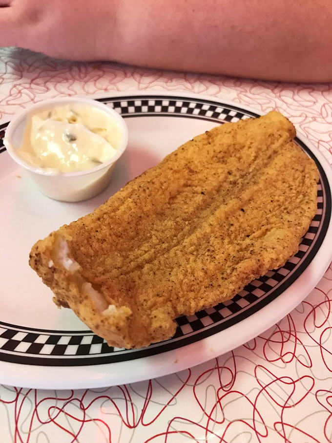 This cornmeal-crusted catfish isn't just fried—it's transformed into a golden-brown masterpiece that would make Southern grandmothers nod in solemn approval.