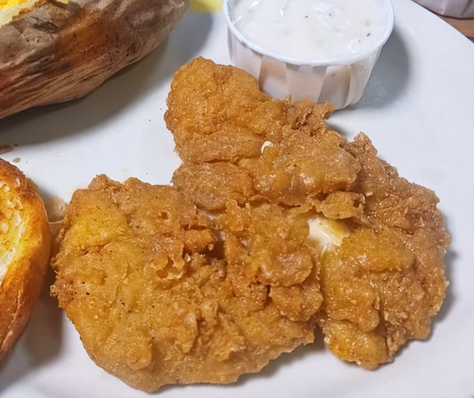 Golden-fried chicken that crackles with each bite – the kind that makes you wonder why anyone bothered to invent fancy cooking techniques.