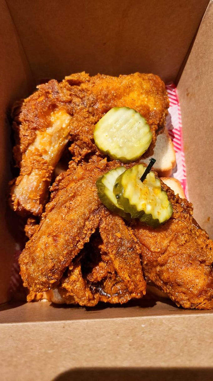 Golden-brown perfection with pickle coins standing guard. This isn't just fried chicken—it's Nashville's edible ambassador to the world.