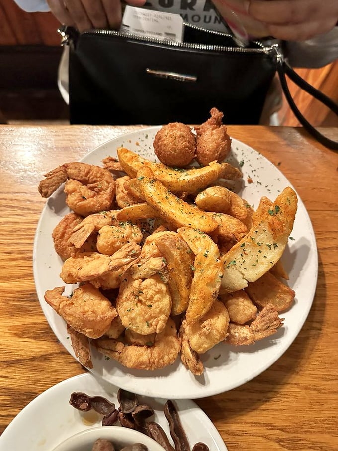 Golden-fried shrimp and potato wedges arranged like a delicious game of Jenga—pull one out and you'll be tempted to take another.