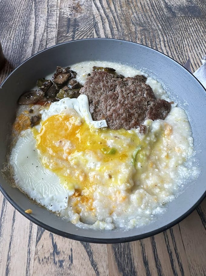 A skillet of comfort that whispers, "Don't worry about cholesterol today." Grits, eggs, and meat in perfect harmony – the breakfast equivalent of a Grammy-winning trio.