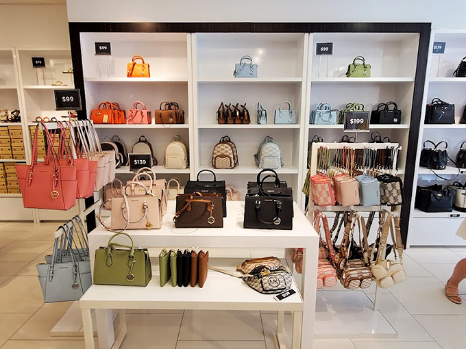 Handbag paradise unfolds in neat rows of leather temptation, where Michael Kors purses wait patiently to find their forever homes and empty wallets.
