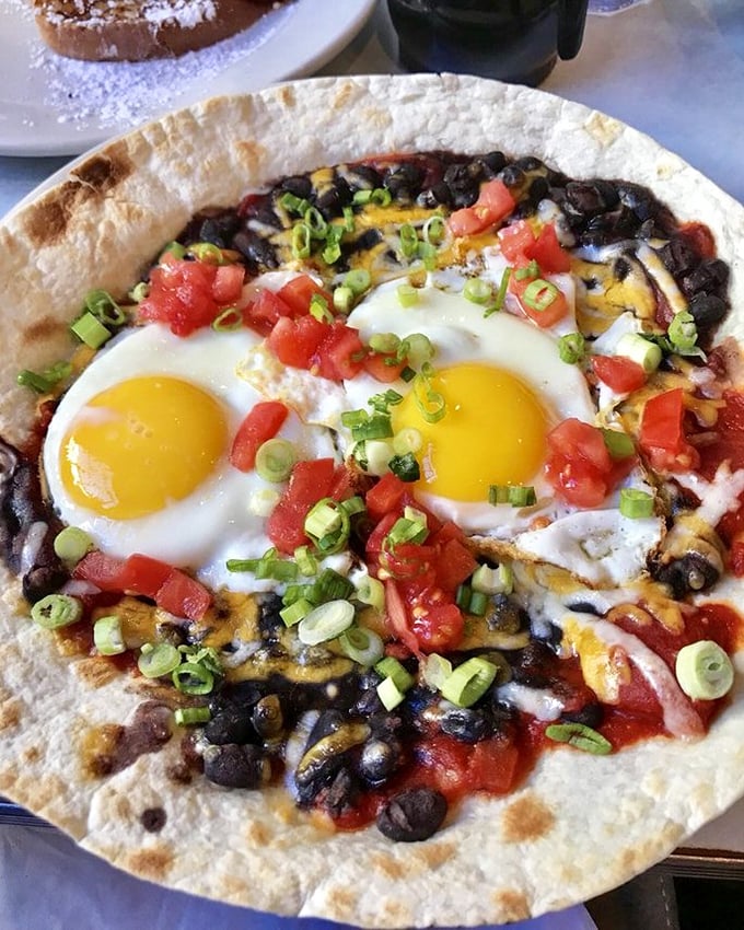 Huevos Rancheros that dance on the plate—sunny eggs, black beans, and fresh tomatoes creating a fiesta worth waking up for.