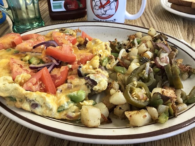 This isn't just an omelet—it's a color wheel of morning delights, with those home fries looking like they've achieved the perfect crisp-to-tender ratio.