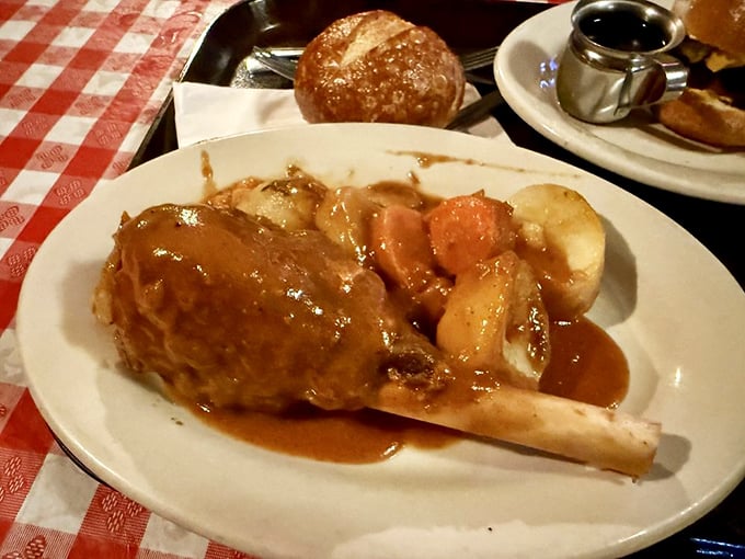 The lamb shank looks like it belongs in a medieval feast scene—tender meat falling off the bone, swimming in gravy that deserves its own fan club.