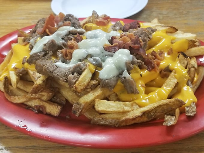 The loaded fries that launched a thousand road trips. Crispy potatoes smothered in steak, cheese, and bacon—a glorious mountain of indulgence worth every mile driven.