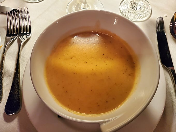 This golden lobster bisque isn't just soup—it's a warm embrace in a bowl, rich with seafood essence and velvety texture.
