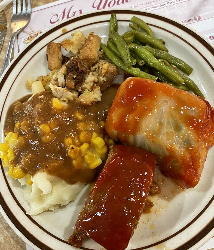 Mashed potatoes swimming in gravy with meatloaf wearing a saucy red jacket—comfort food that speaks the universal language of "mmmmm."