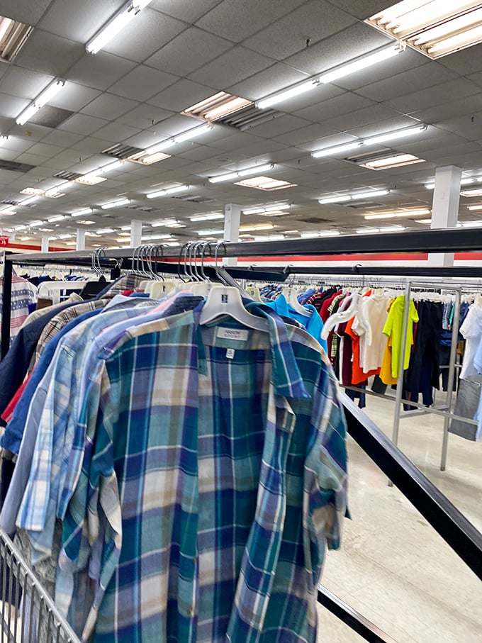 Plaid paradise! Men's shirts hang like colorful soldiers at attention, ready for their second act in someone else's wardrobe rotation.