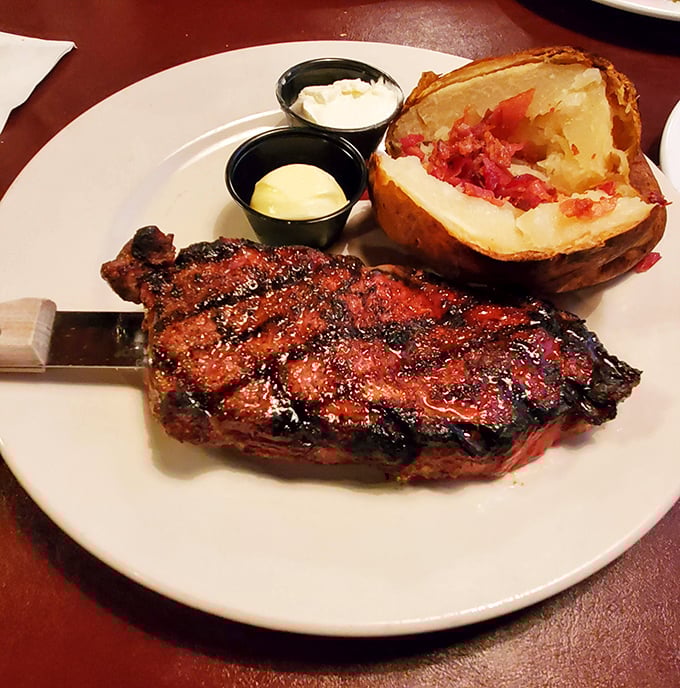 A New York strip that's dressed for success with those perfect grill marks. That loaded baked potato isn't just a side—it's making a compelling case for co-stardom.