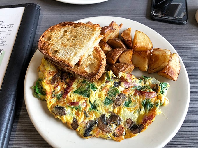 This isn't just an omelet; it's a garden party wrapped in eggs, with toast standing by ready to soak up any escaped goodness.