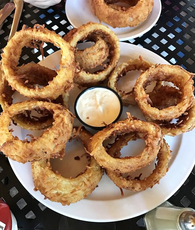 These onion rings aren't just appetizers – they're golden halos of crispy perfection with a dipping sauce worthy of your devotion.