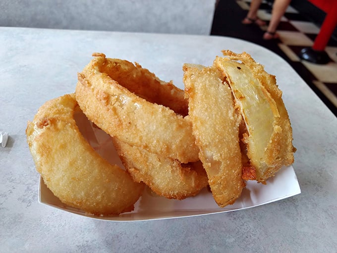 These onion rings aren't just fried—they're golden halos of crispy perfection that make angels weep with deep-fried joy.