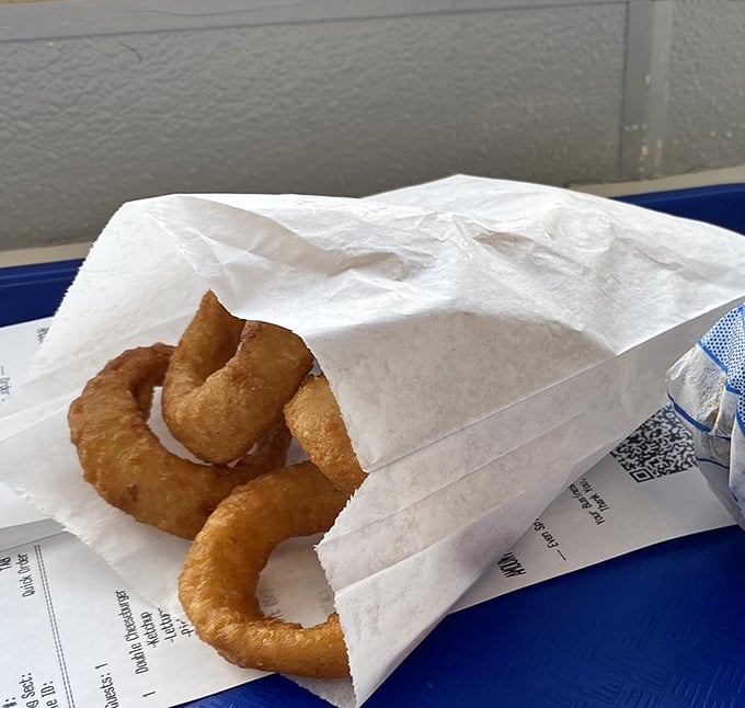 Golden-fried onion rings that crunch like autumn leaves. The perfect sidekick to any sandwich superhero.