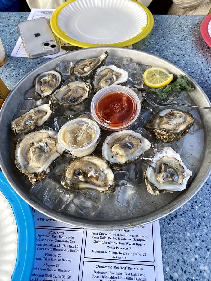 These oysters aren't just served; they're presented like the treasures they are – glistening on ice, waiting for just a squeeze of lemon to reach perfection.