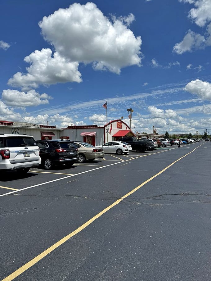 The distinctive red barn-style architecture creates that perfect blend of country charm and retail therapy under brilliant Ohio skies.
