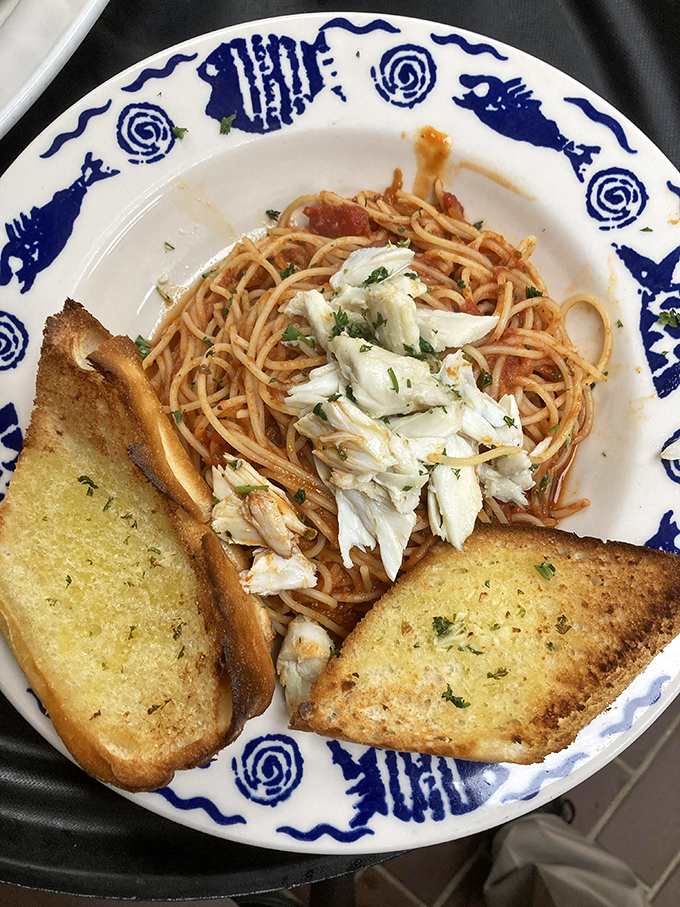 Spaghetti with fresh crab meat and garlic bread—proof that sometimes the simplest combinations create the most profound happiness.