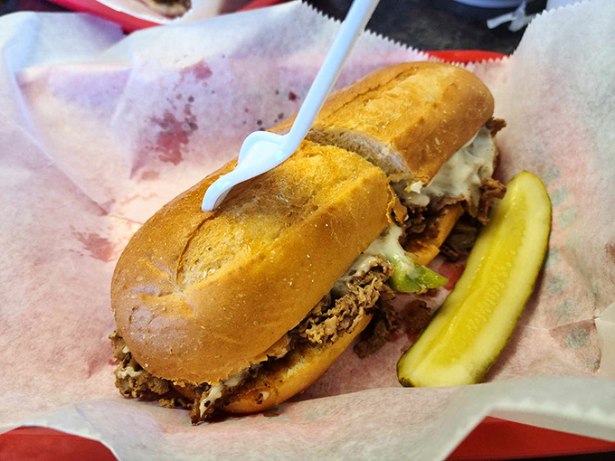 This Philly cheesesteak doesn't need Philadelphia's approval—it's confidently Alabama, served with a pickle spear standing guard like it owns the place.