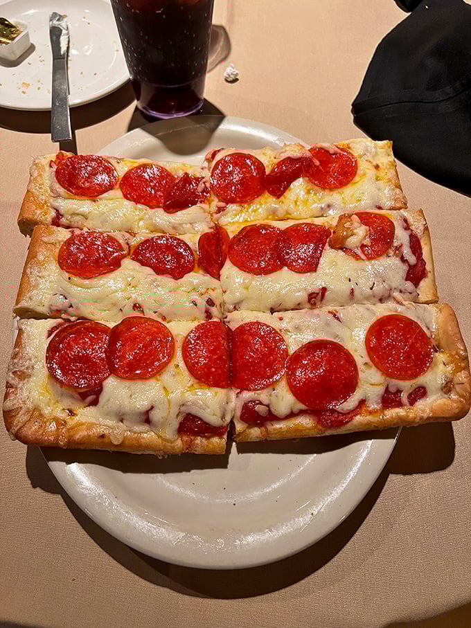 Old Forge-style pizza isn't just rectangular—it's revolutionary. Those pepperoni coins aren't toppings; they're edible treasure on a cheese-laden map.