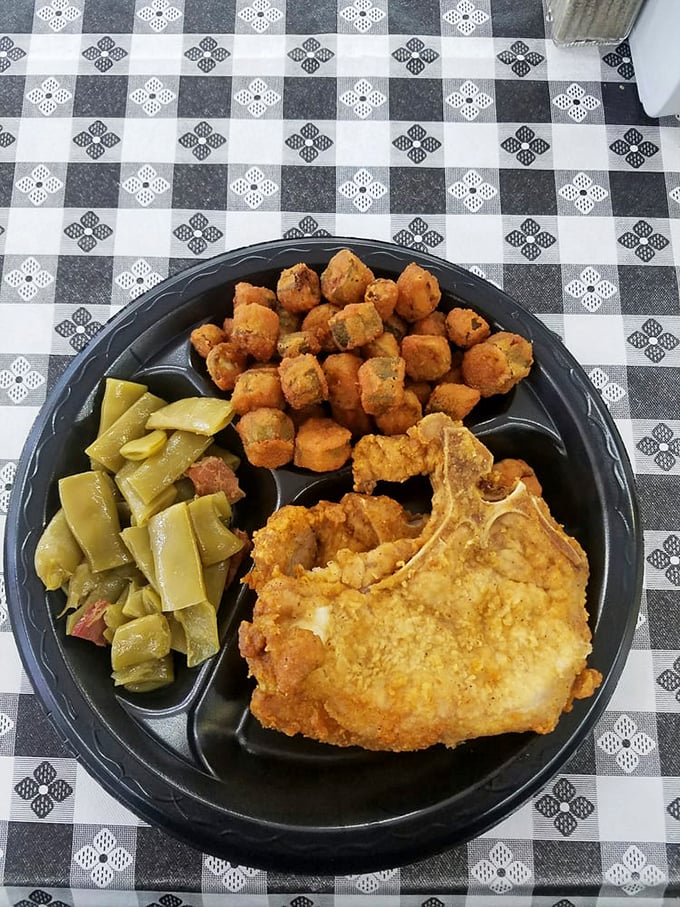 Southern comfort on a plate—crispy pork chop, perfectly fried okra, and sides that make you question why you'd eat anywhere else.
