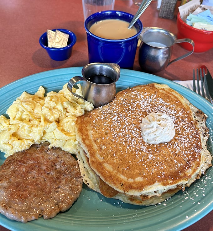 Golden pancakes with a dollop of butter, perfectly scrambled eggs, and a sausage patty—the breakfast equivalent of hitting the lottery.